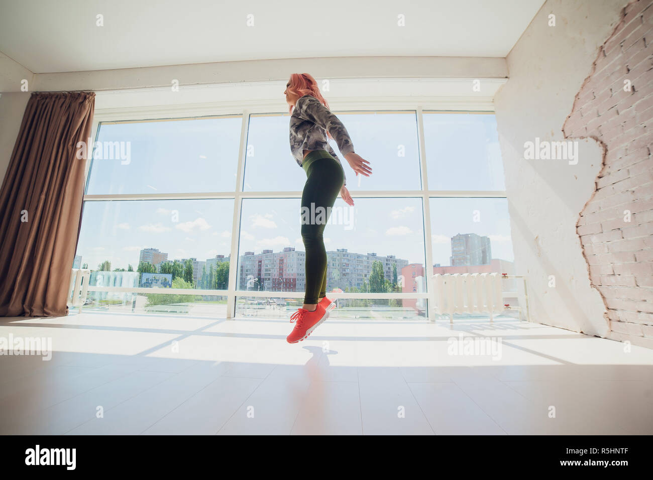 Horizontal shot of slim sporty woman has nice healthy muscular body ...