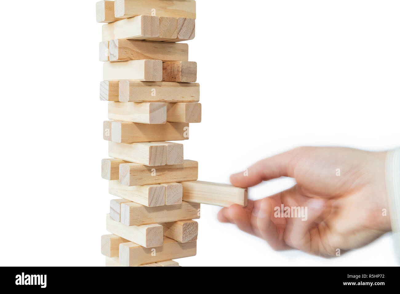 Man's hand taking or putting a block to an unstable and incomplete ...