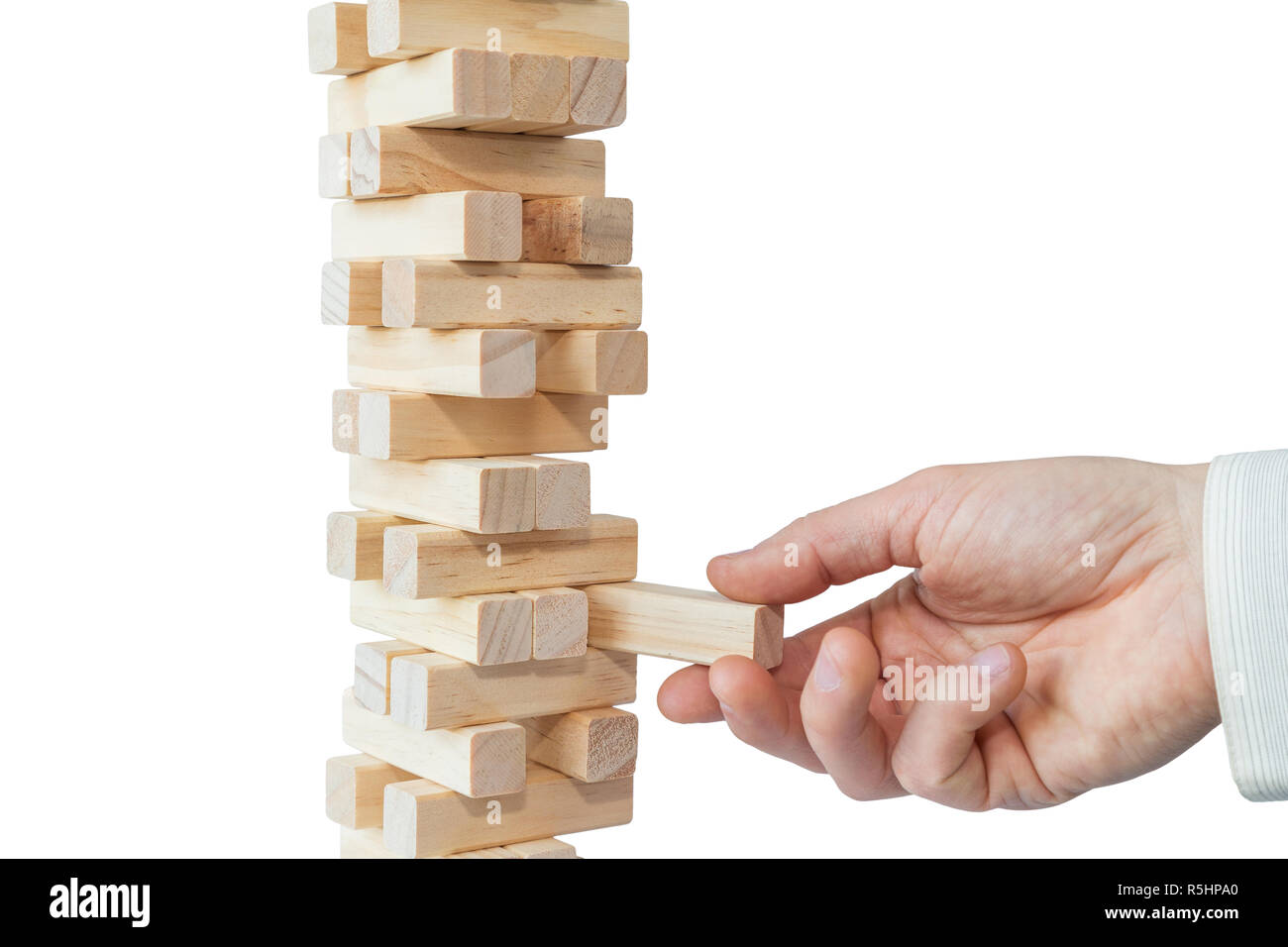 Man's hand taking or putting a block to an unstable and incomplete ...