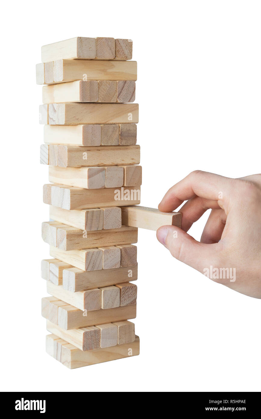 Man's hand taking first block or putting the last block to a sturdy ...