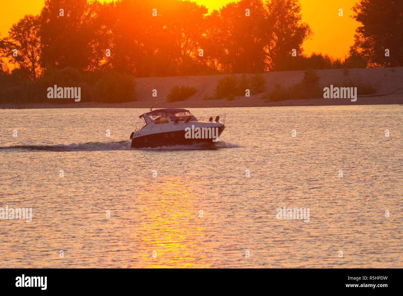 luxury motor boat at sunset on the river Stock Photo - Alamy