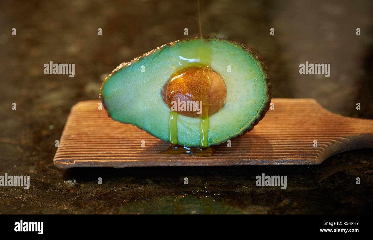 Avocado with olive oil Stock Photo - Alamy