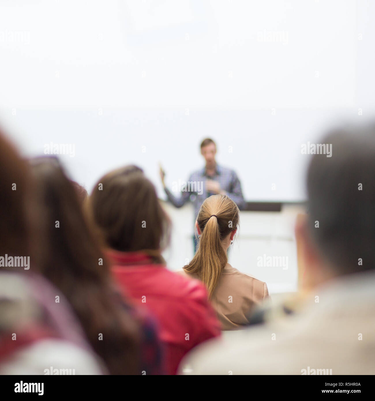 Man giving presentation in lecture hall at university Stock Photo - Alamy