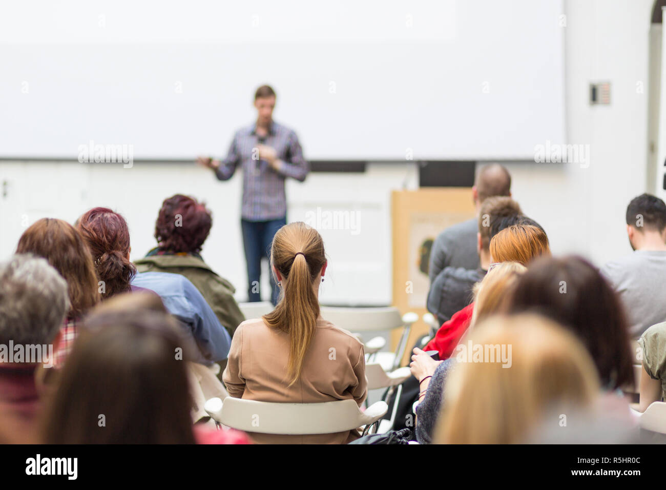 Man giving presentation in lecture hall at university Stock Photo - Alamy