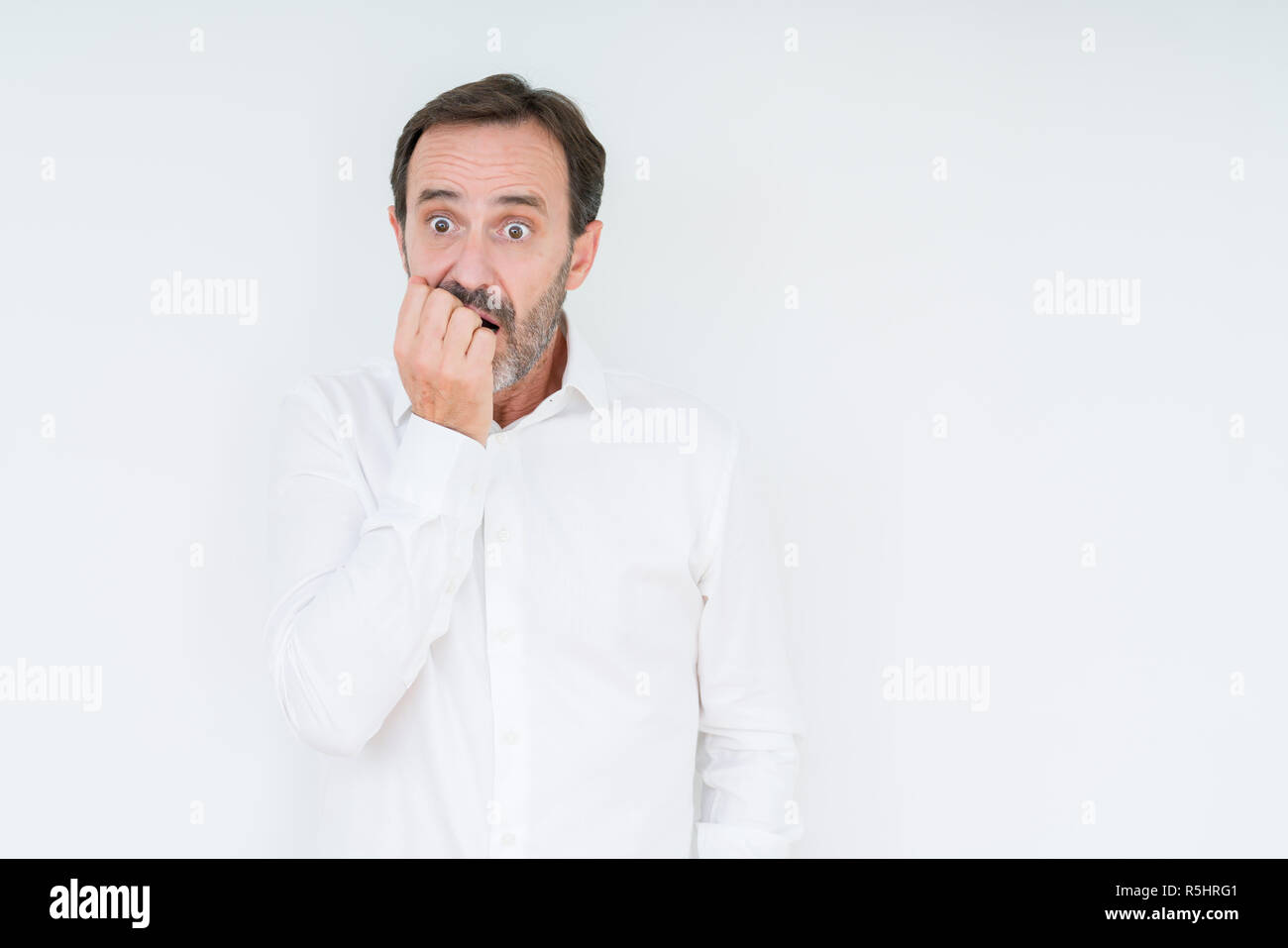 Elegant senior man over isolated background looking stressed and ...