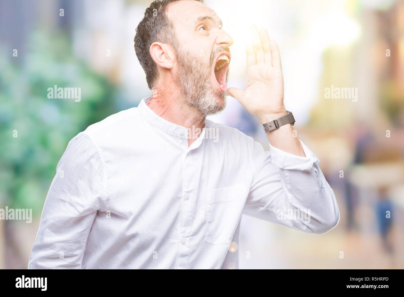 Middle age hoary senior man over isolated background shouting and ...