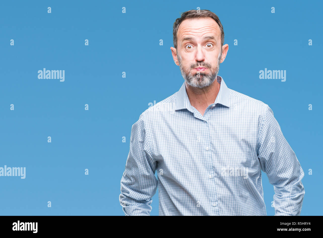 Middle age hoary senior business man over isolated background puffing ...