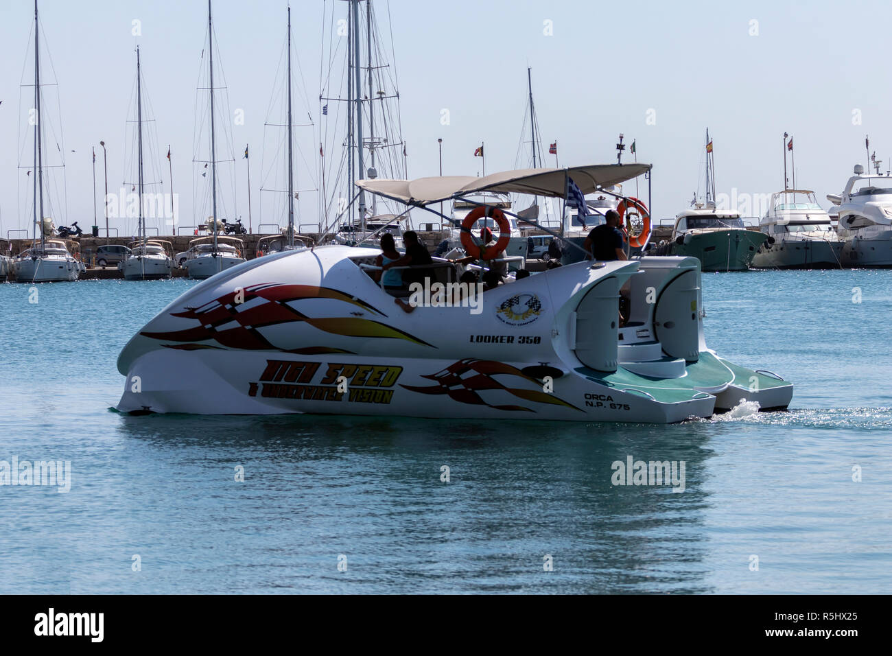 RODOS TOWN, RHODES, GREECE, August 25, 2018: A group of tourists sail ...
