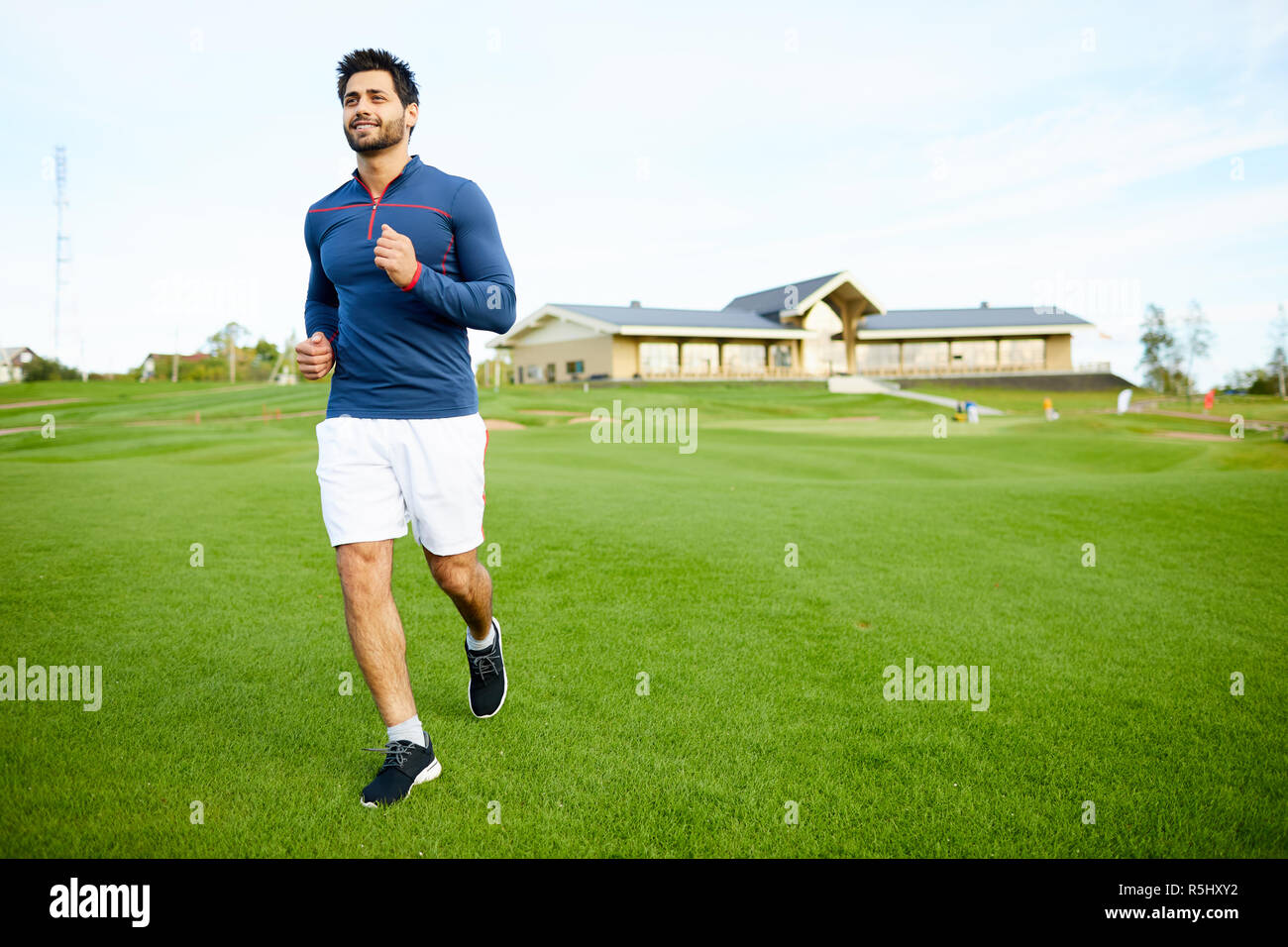 Jogging on green field Stock Photo - Alamy