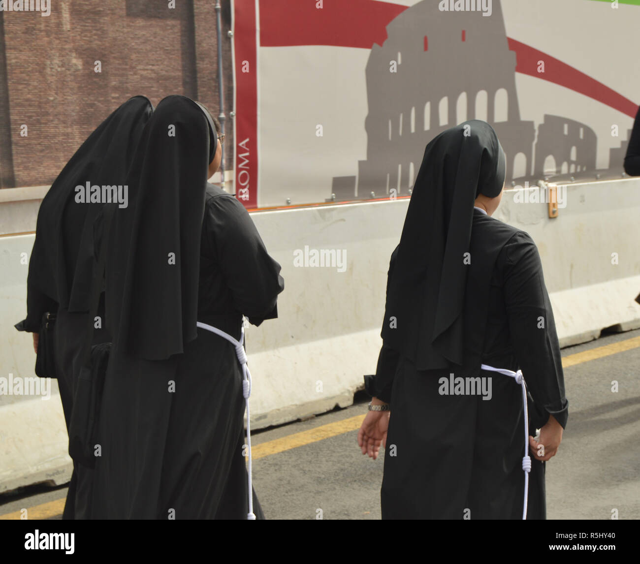 Rome, Italy-October 07, 2018, three nuns dressed in black robes walking ...
