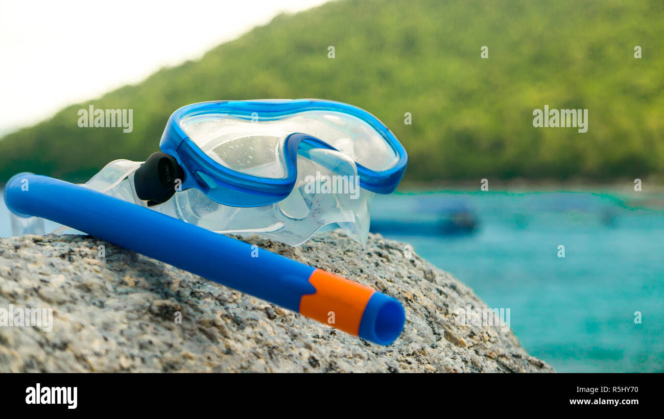 Snorkeling equipment: snorkel and diving google on the stone. Tropical ...