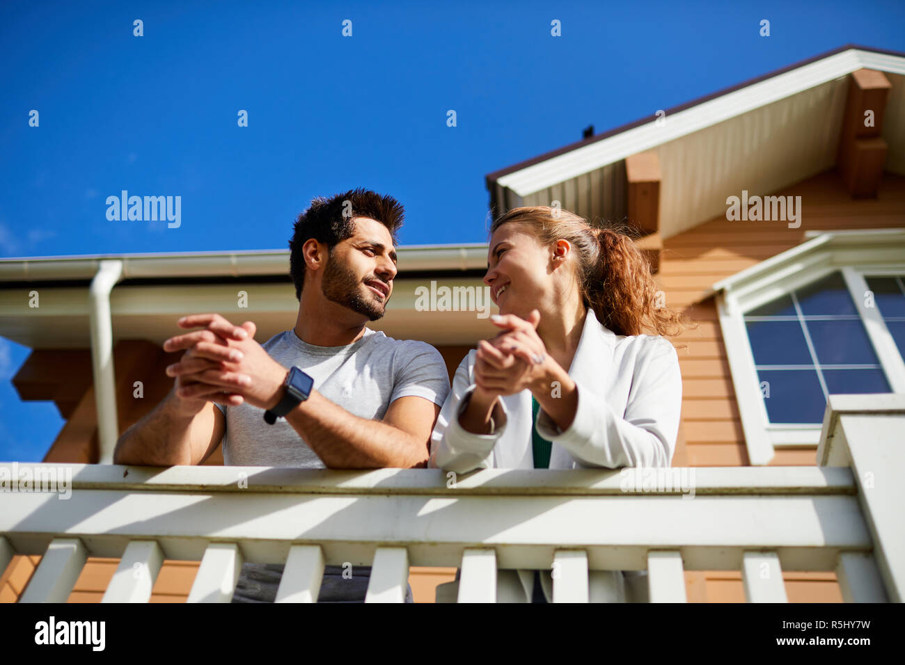 Talking on balcony Stock Photo - Alamy