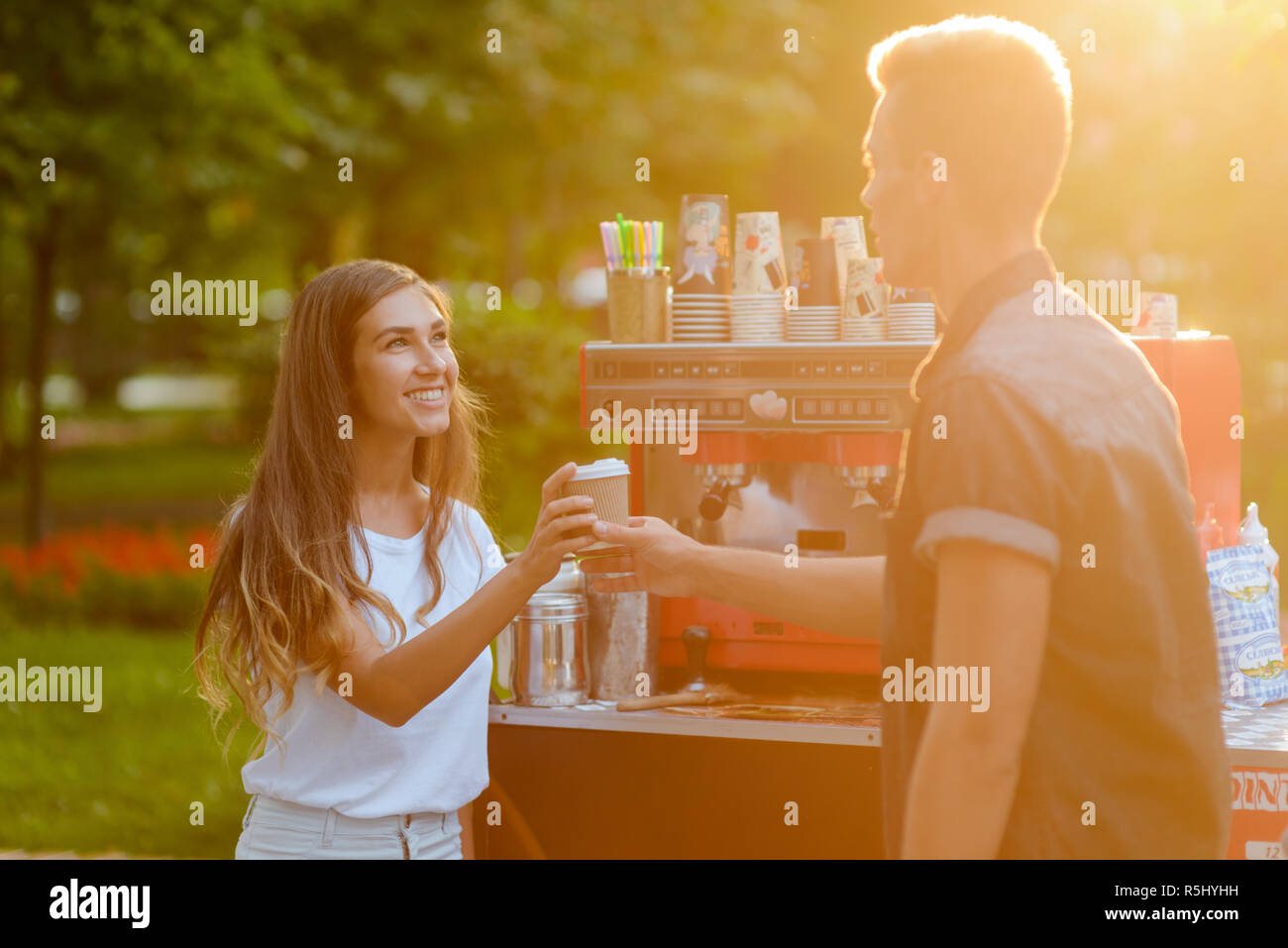 Girl giving paper boy hi-res stock photography and images - Alamy