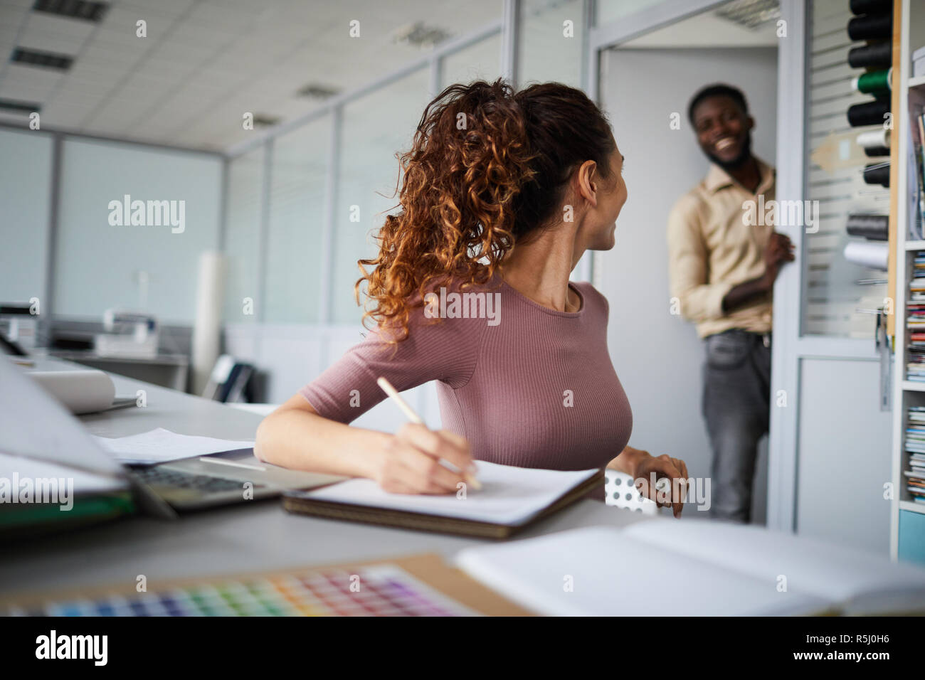 Talking to colleague Stock Photo - Alamy