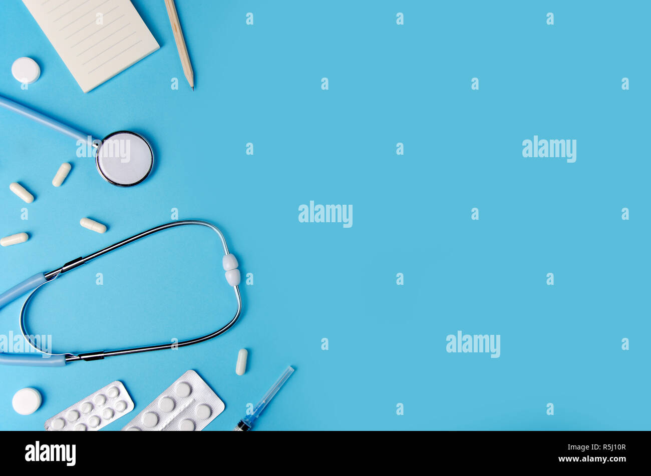 Medical concept blue background. Doctor's desk with instruments. Copy ...