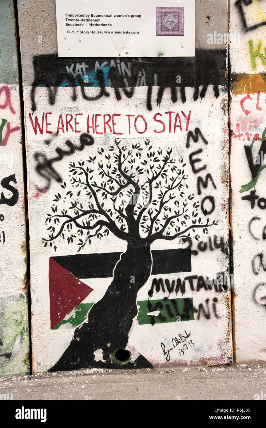 Graffiti of tree on separation wall in Bethlehem, West Bank."we are ...