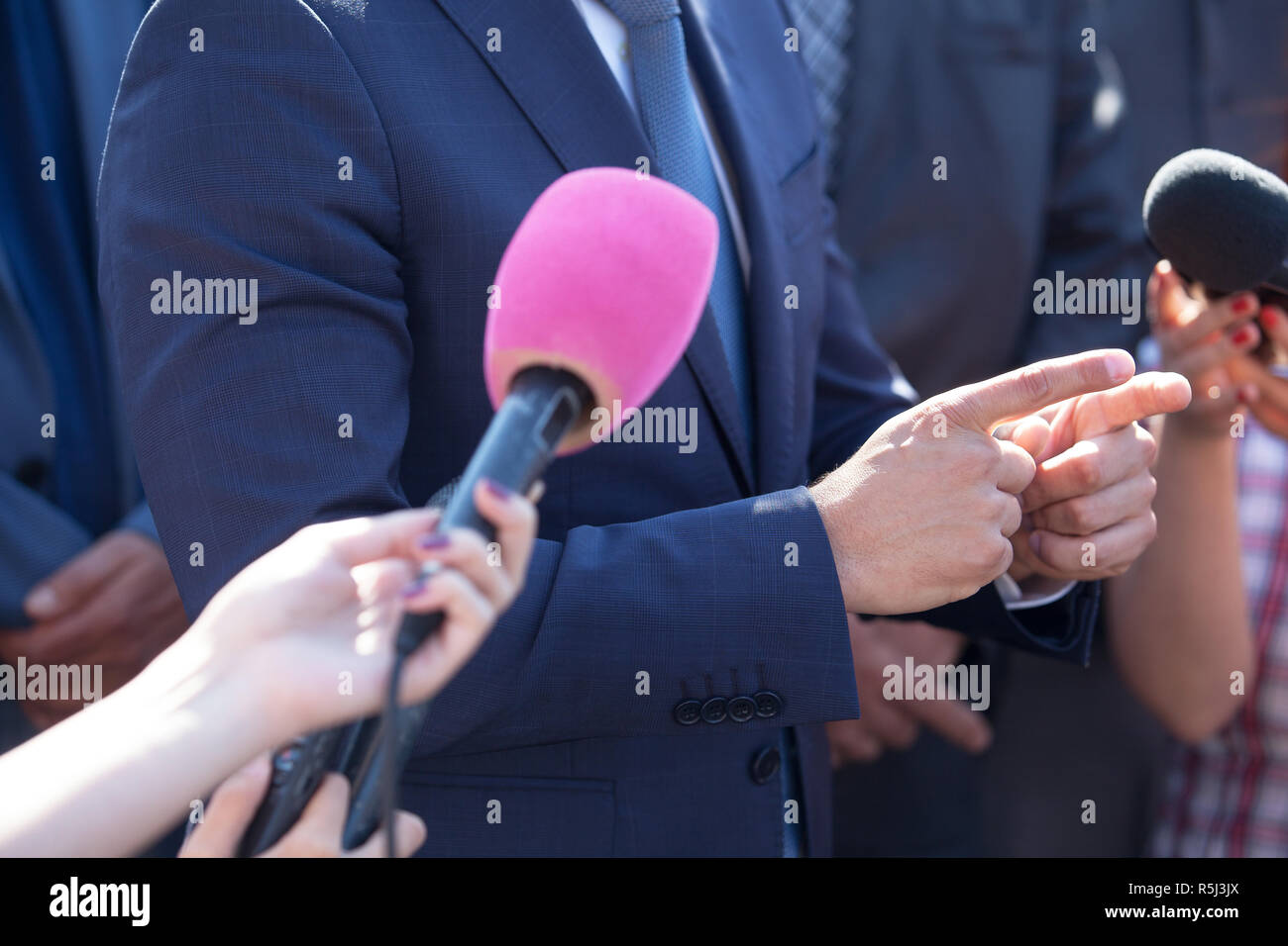 Media interview. Hand gesture. Business person Stock Photo - Alamy