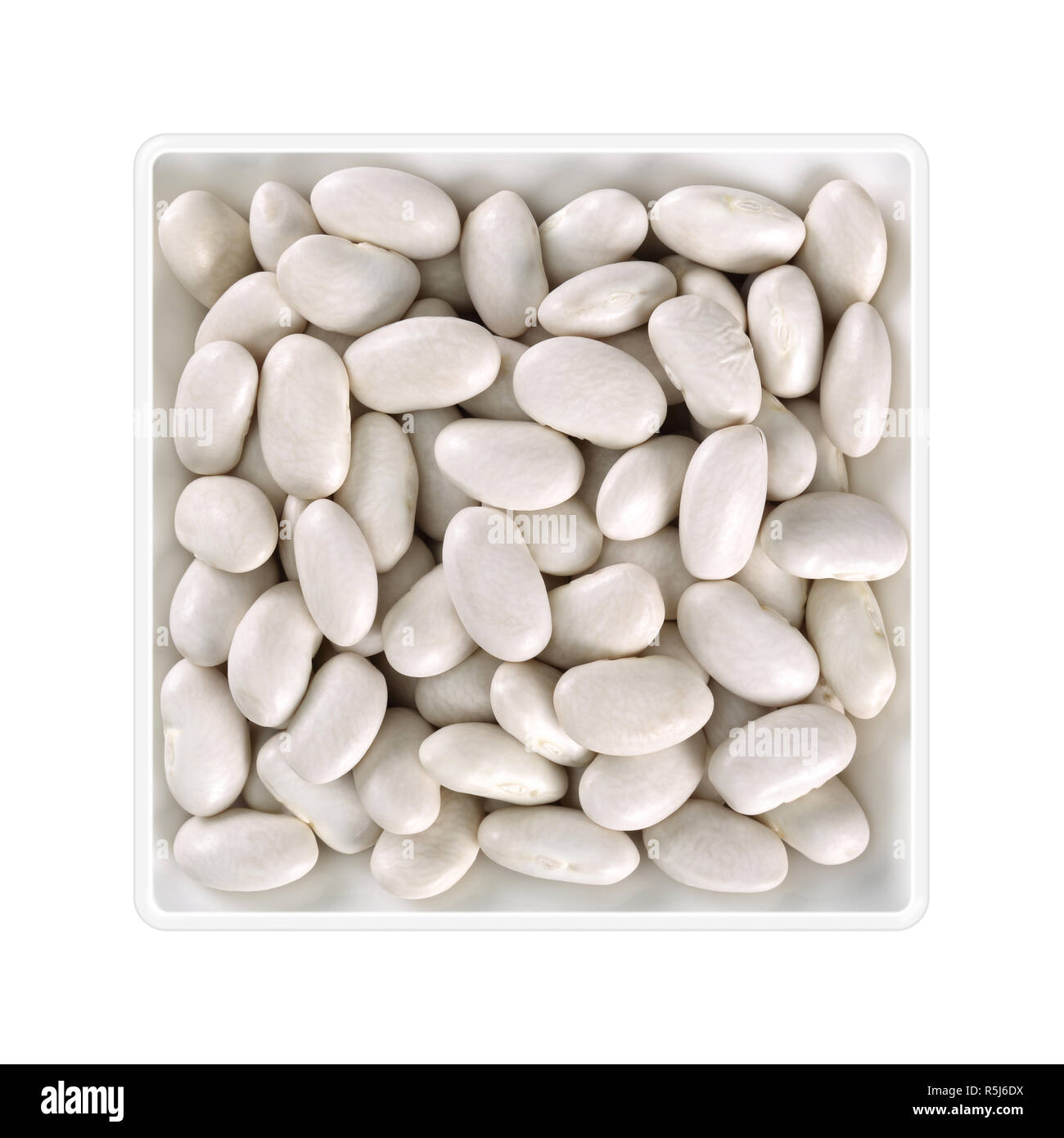White beans in square bowl on white background Stock Photo - Alamy