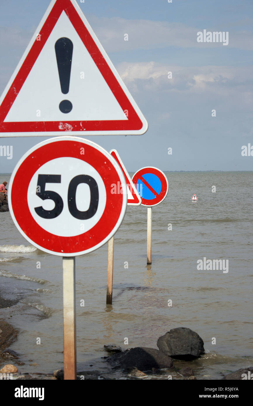 Road signs on road that gets flooded by tidal water in la Vendee France ...