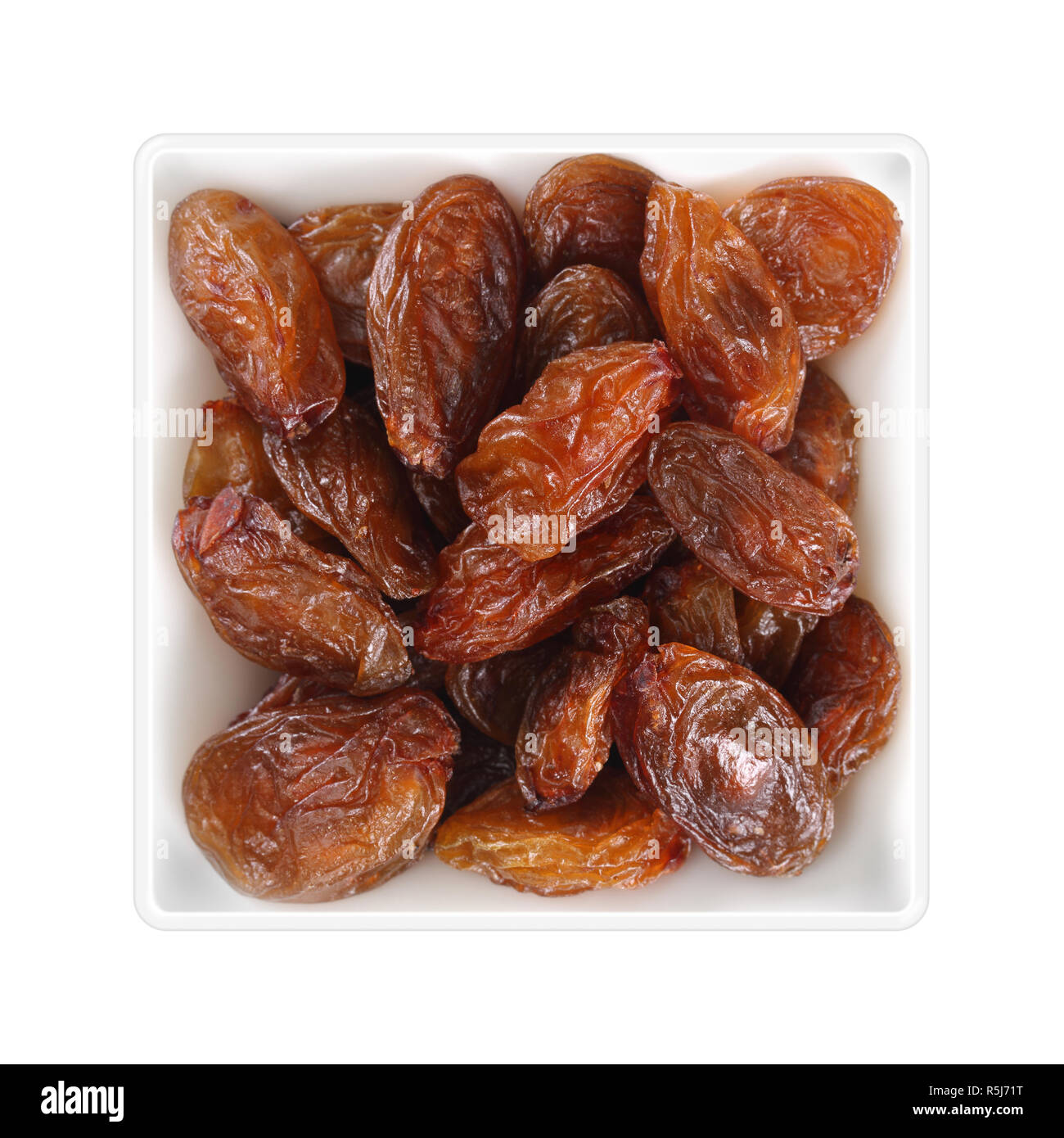 Seeded raisins in square bowl on white background Stock Photo - Alamy