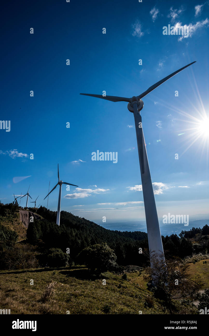 Wind power generators standing in the beam of the Sun. Aoyama plateau ...