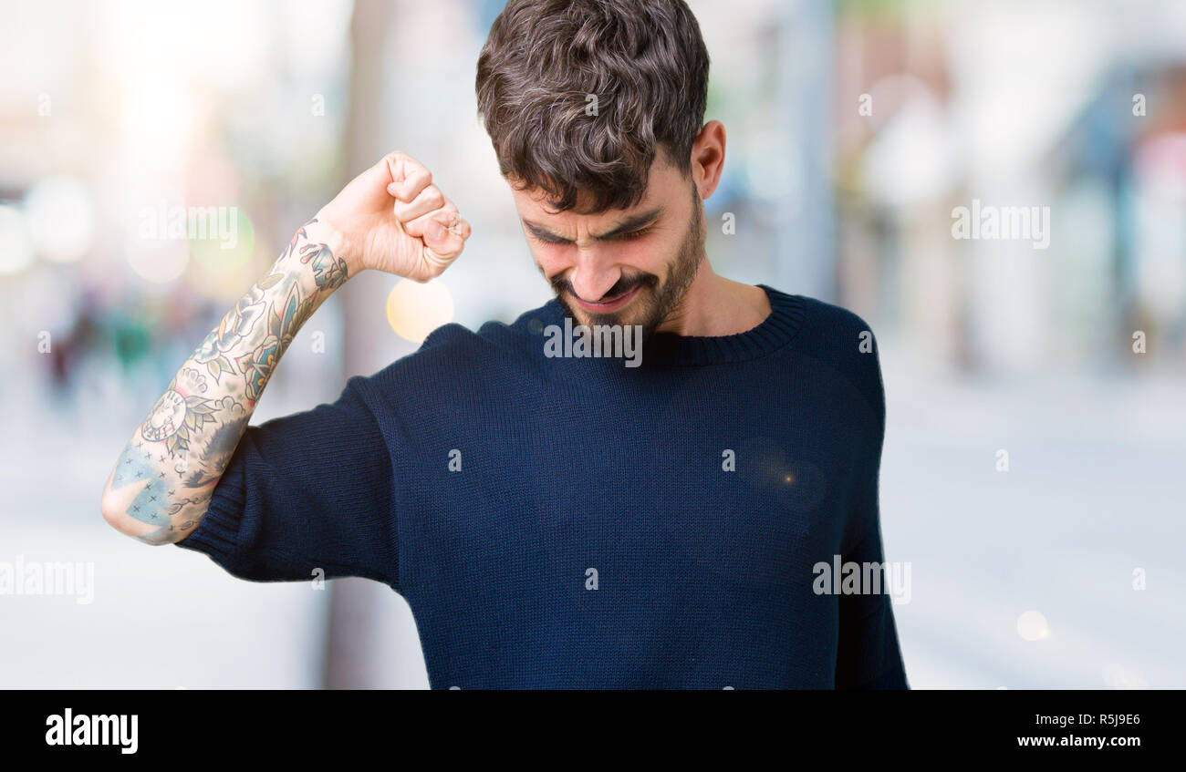 Young handsome man over isolated background stretching back, tired and ...