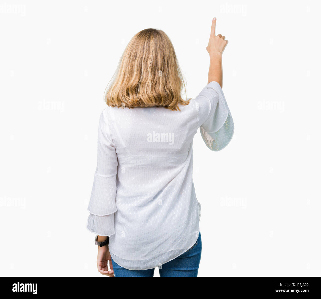 Beautiful young elegant woman over isolated background Posing backwards ...