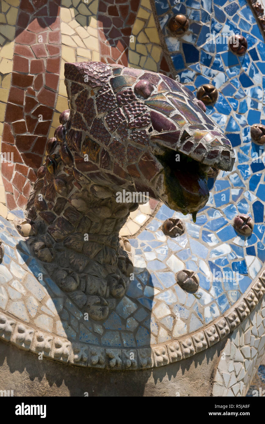 A decorative animal head made of colourful mosaic in the Park Guell ...