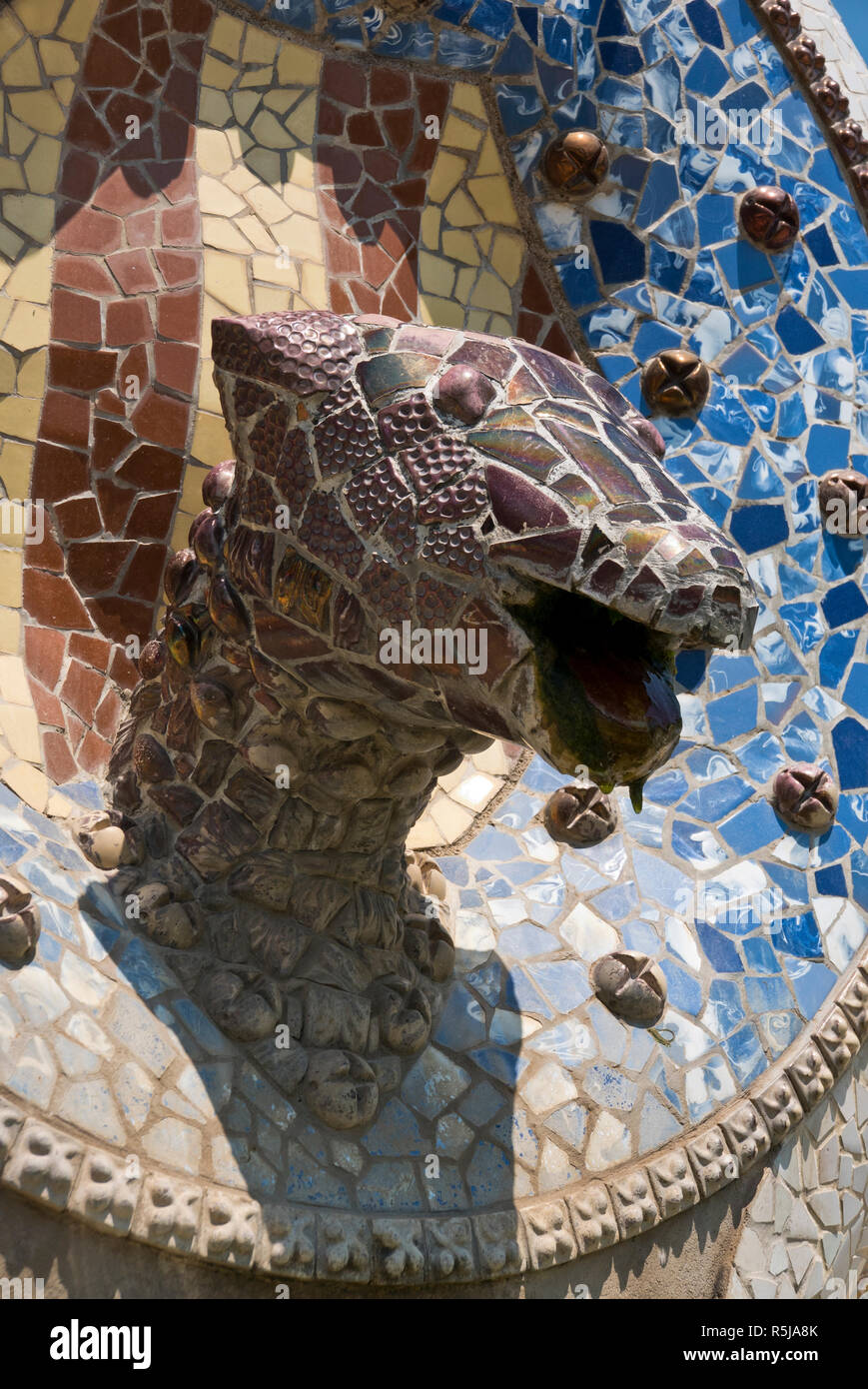 A decorative animal head made of colourful mosaic in the Park Guell ...