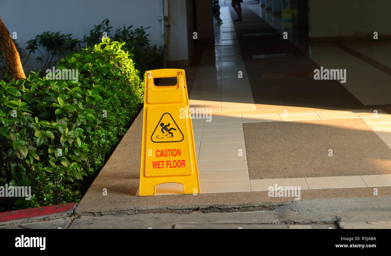 Closeup image of old yellow warning sign read caution wet floor, on ...
