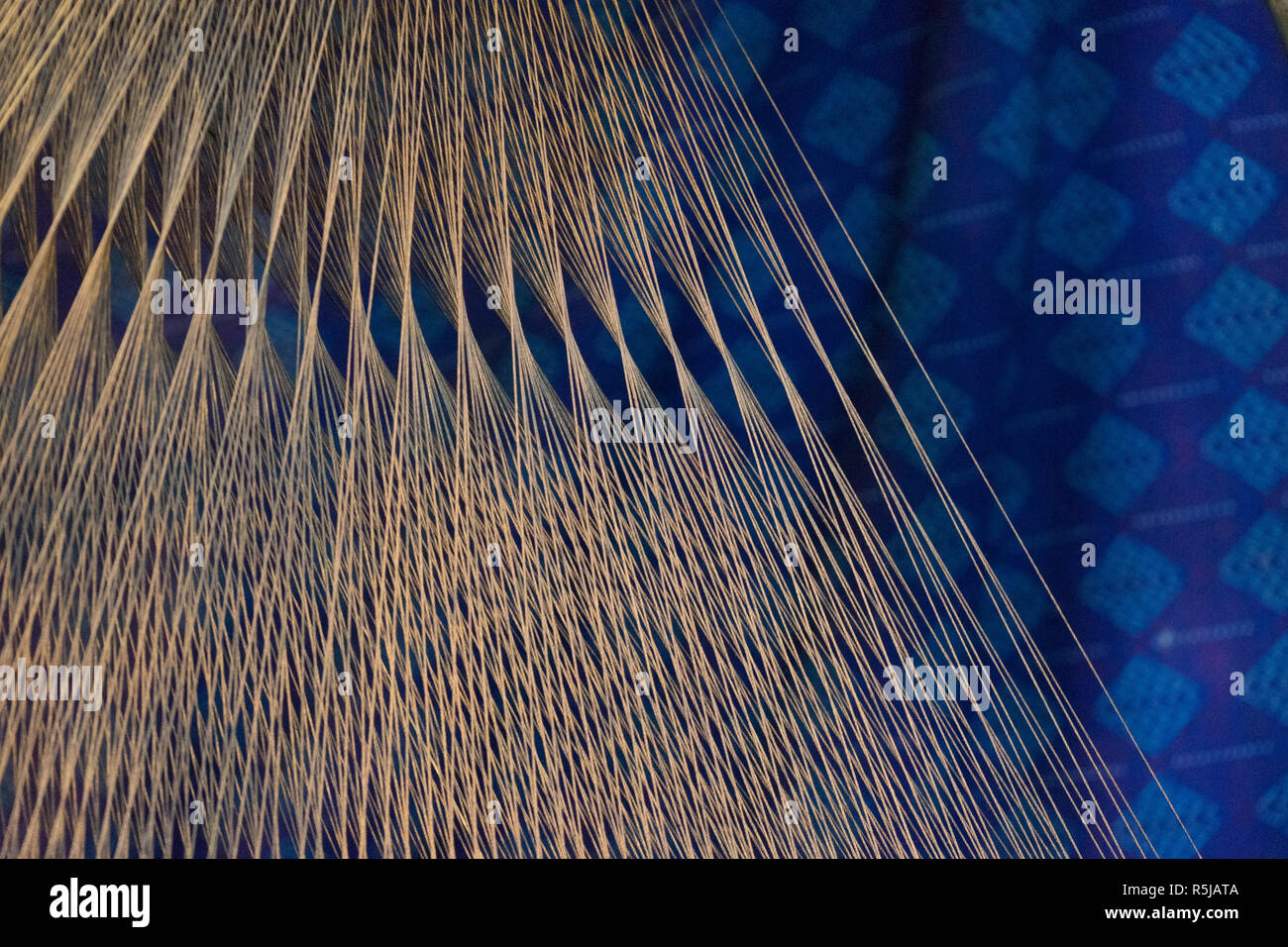 Weaving threads into a colorful cloth Stock Photo - Alamy
