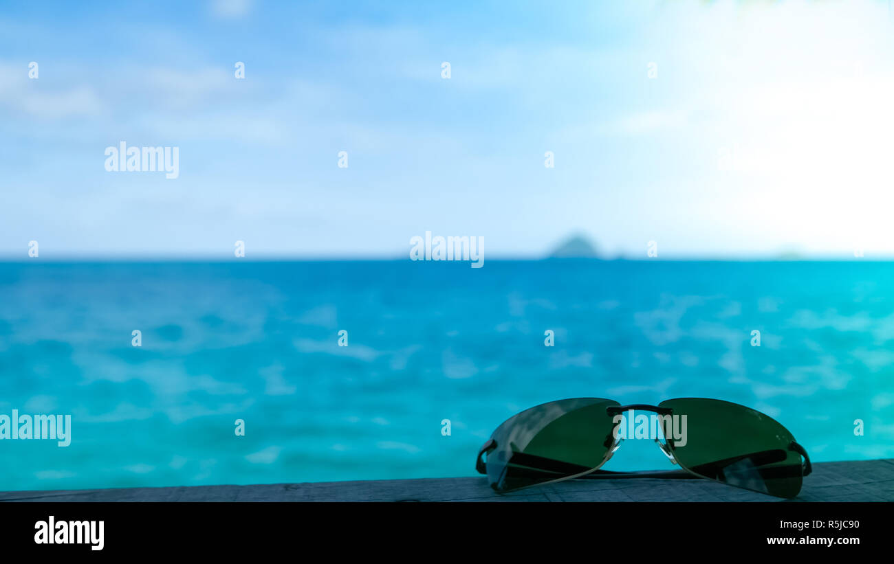 Single sunglasses on tropical sea background with flare effect Stock ...