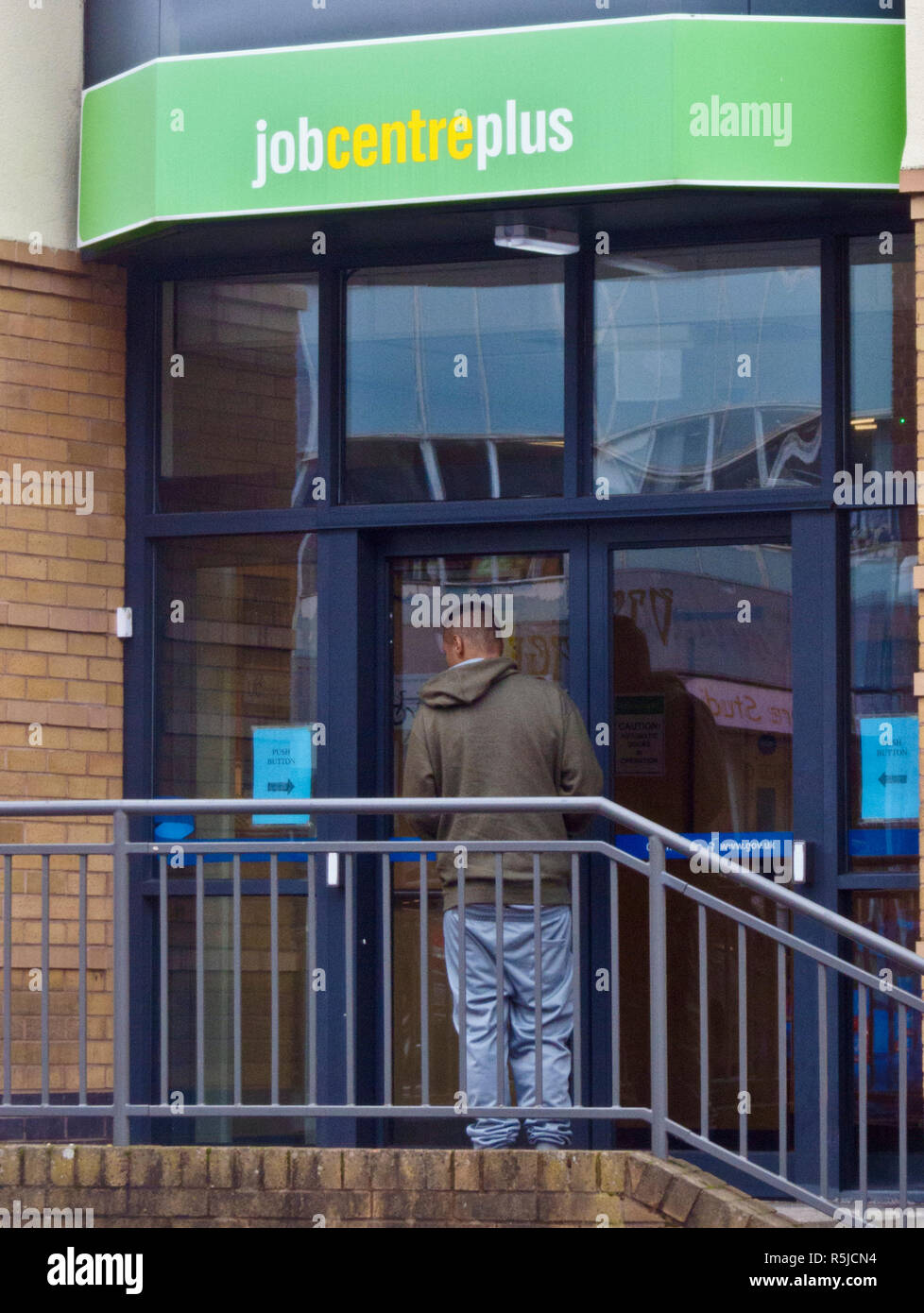 Young Black Man Entering A Job Centre Plus Branch, UK Stock Photo - Alamy