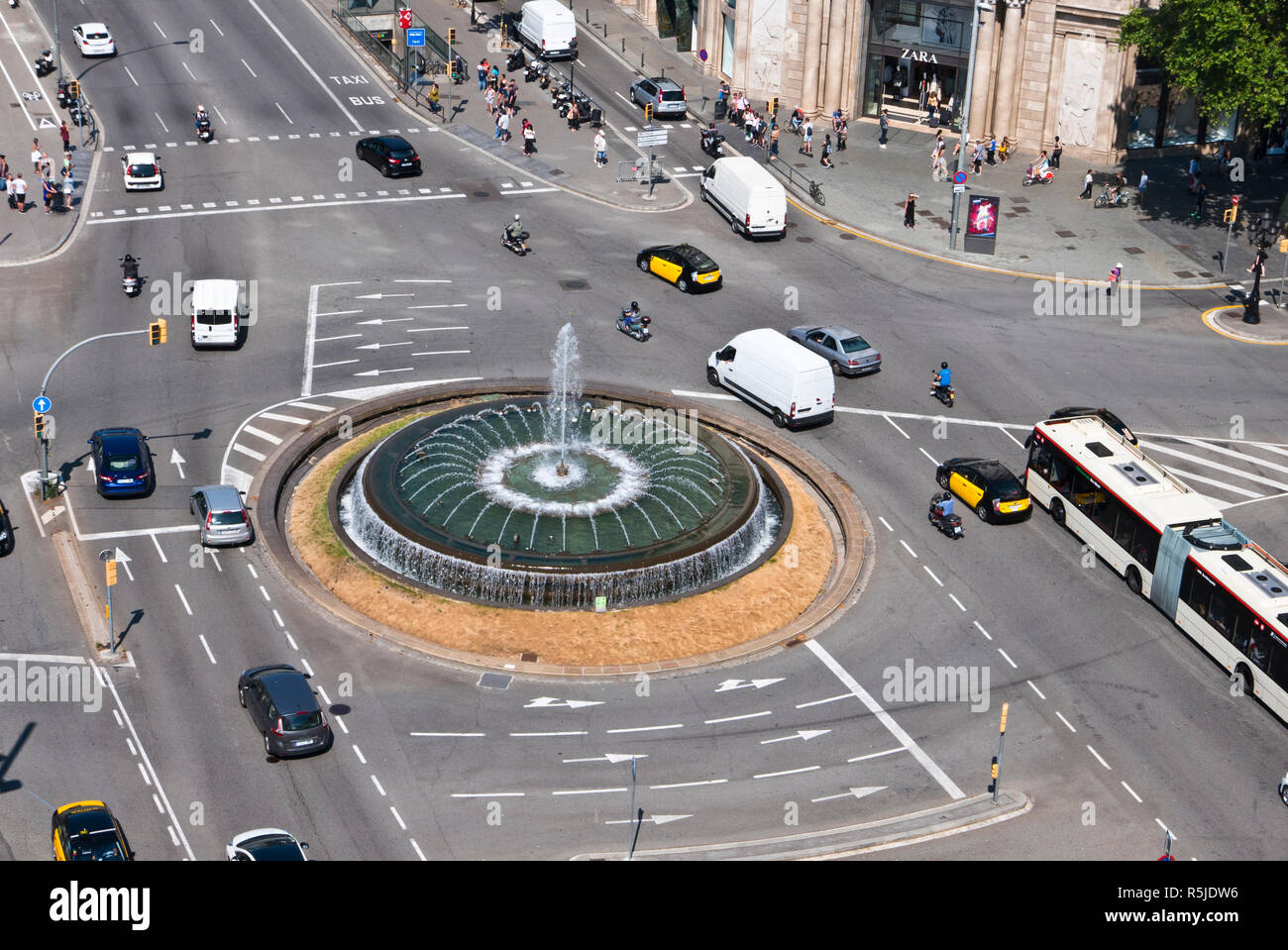 A busy street scene with moving traffic and pedestrians at a major ...