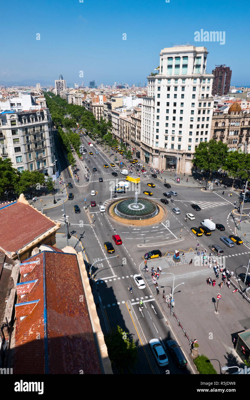 A busy street scene with moving traffic and pedestrians at a major ...