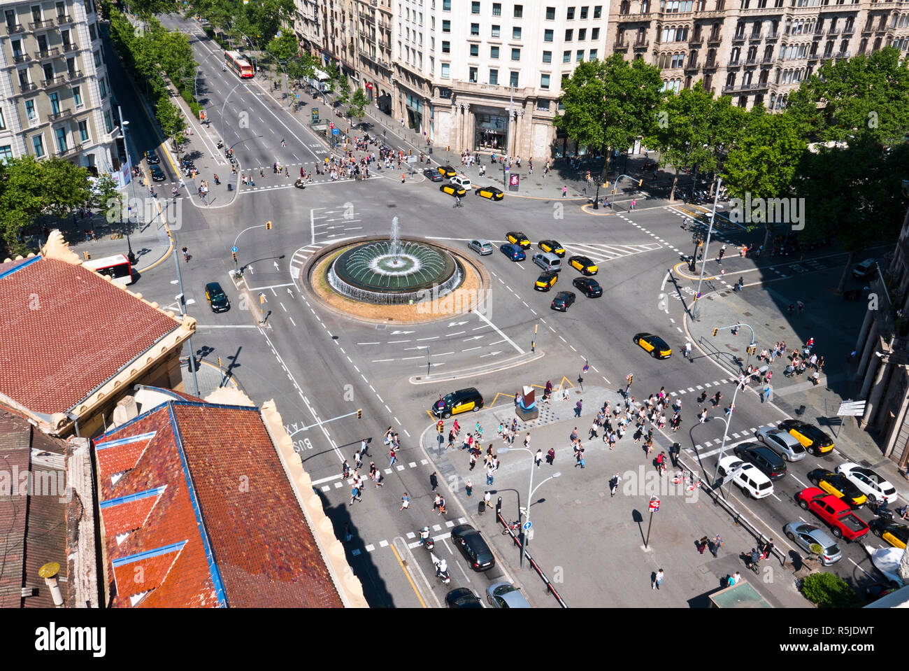 A busy street scene with moving traffic and pedestrians at a major ...