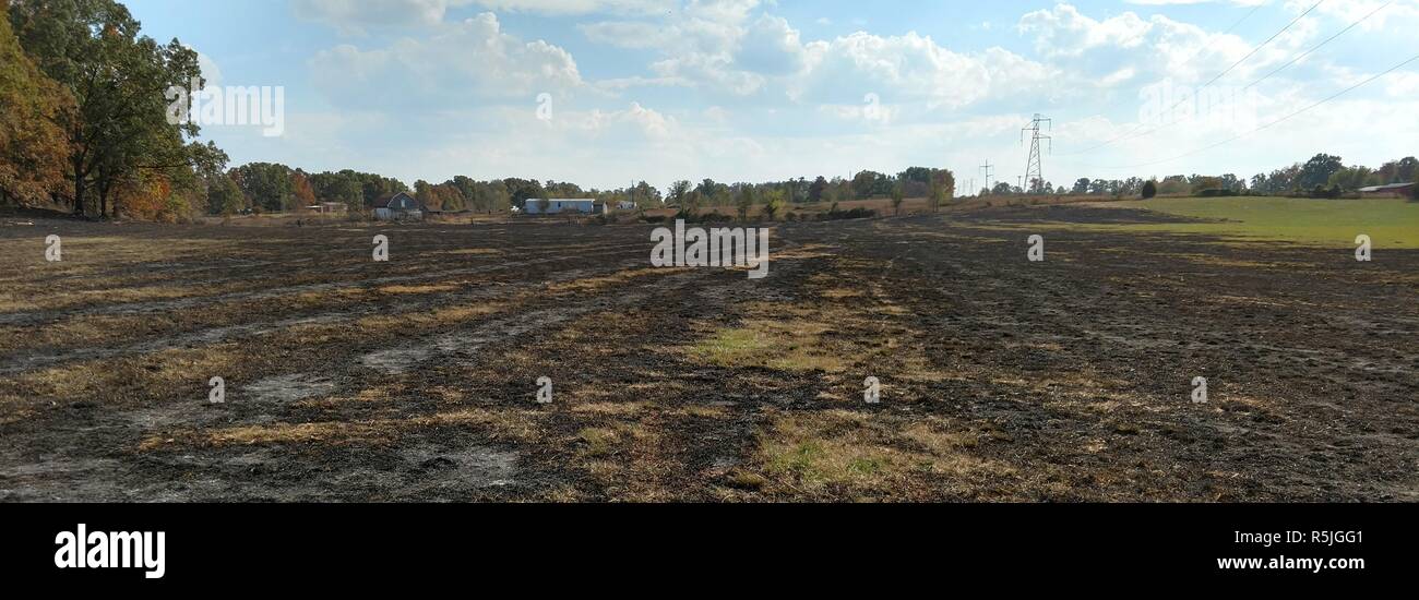 View across burned hay field Stock Photo - Alamy