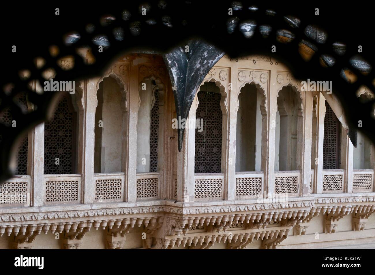 Looking through a scalloped window to a stone carved balcony Stock ...