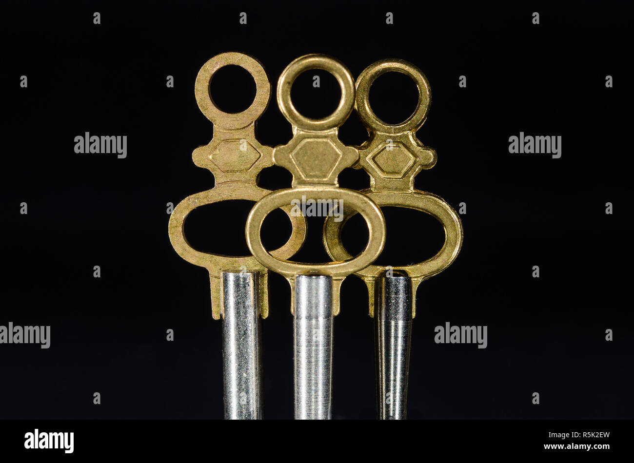 Three Antique Brass Pocket Watch Keys Standing in the Darkness Stock ...