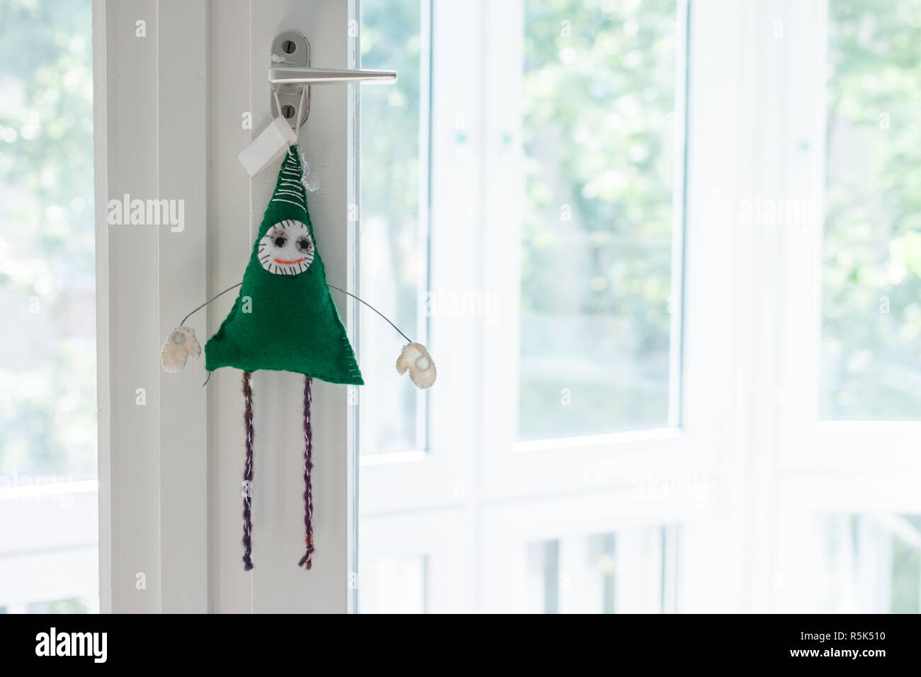 handmade toy green creature on window Stock Photo - Alamy