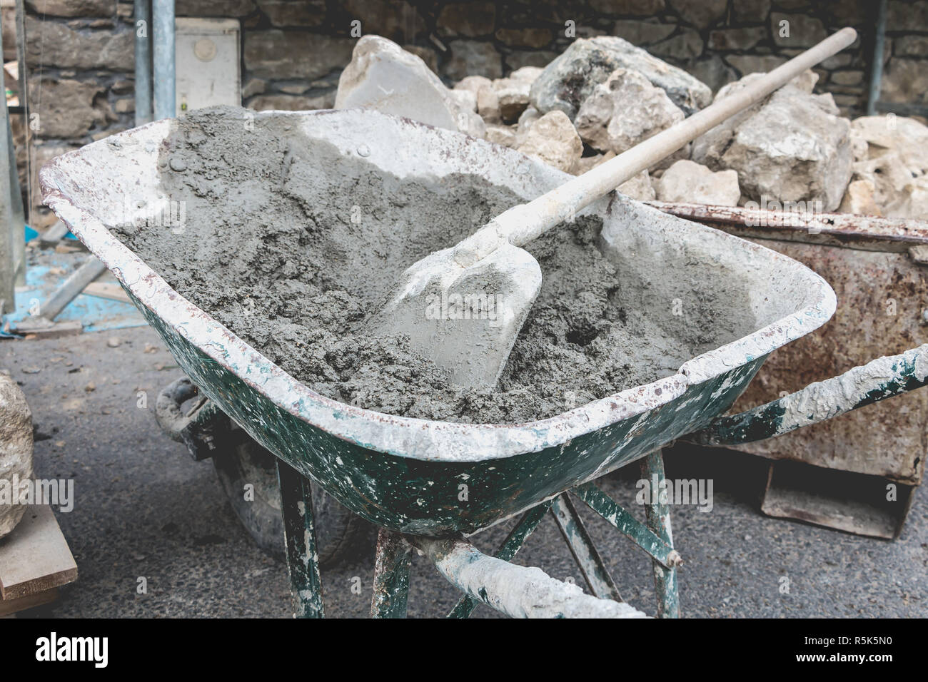 wheelbarrow filled with cement on a renovation project Stock Photo - Alamy
