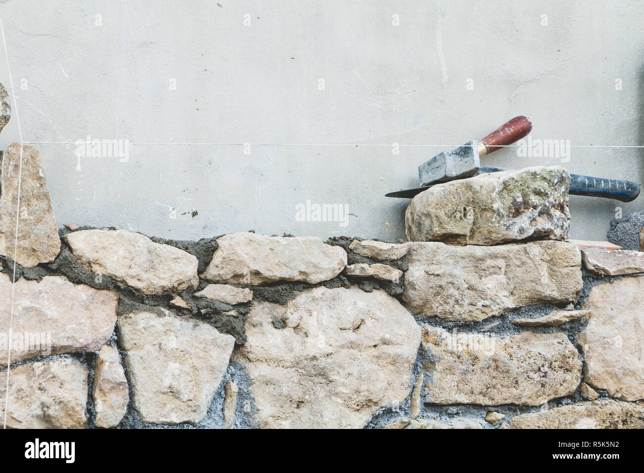 stone wall under construction on a renovation project Stock Photo - Alamy