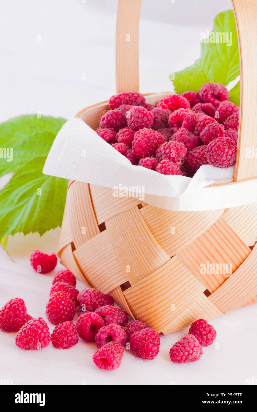 raspberries in a small basket Stock Photo - Alamy