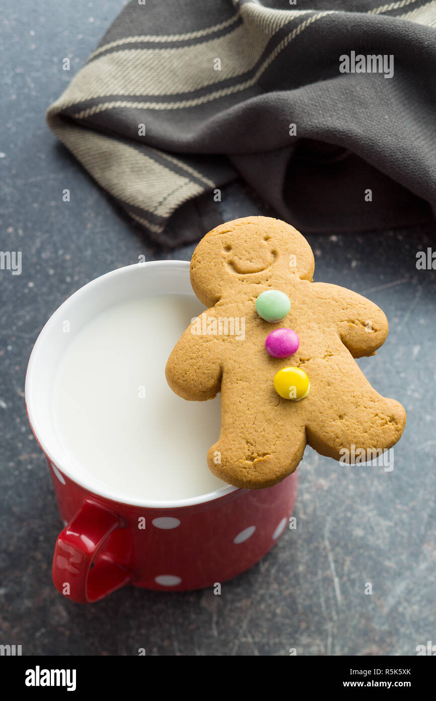Two gingerbread man and mug of milk Stock Photo - Alamy