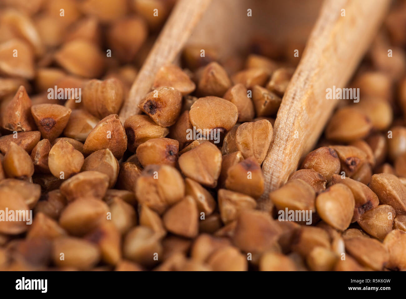 Group of buckwheat groats in a wooden spoon, healthy food Stock Photo ...