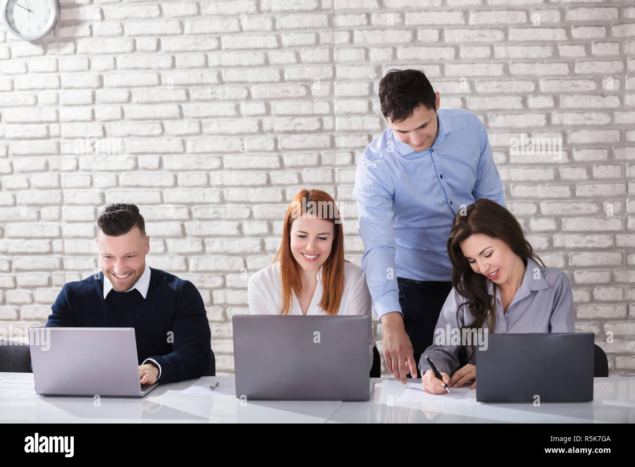 Smiling male staff assisting woman hi-res stock photography and images ...