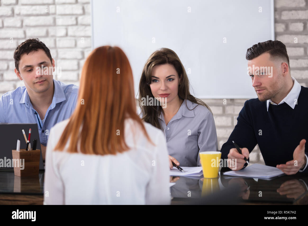 Colleagues talking holding sheet hi-res stock photography and images ...