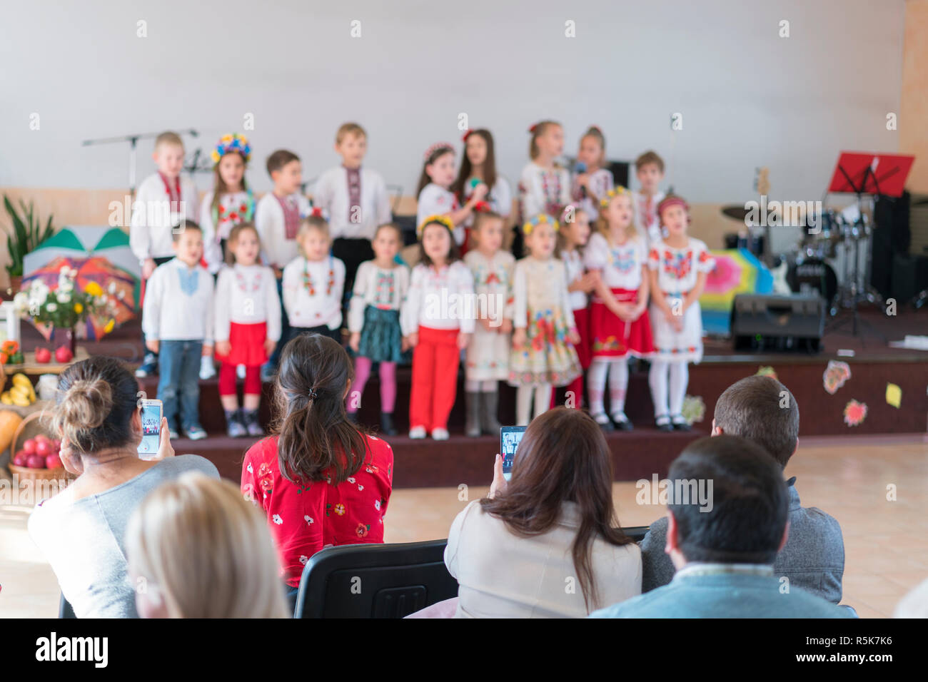Children's holiday in kindergarten. Children on stage perform in front ...
