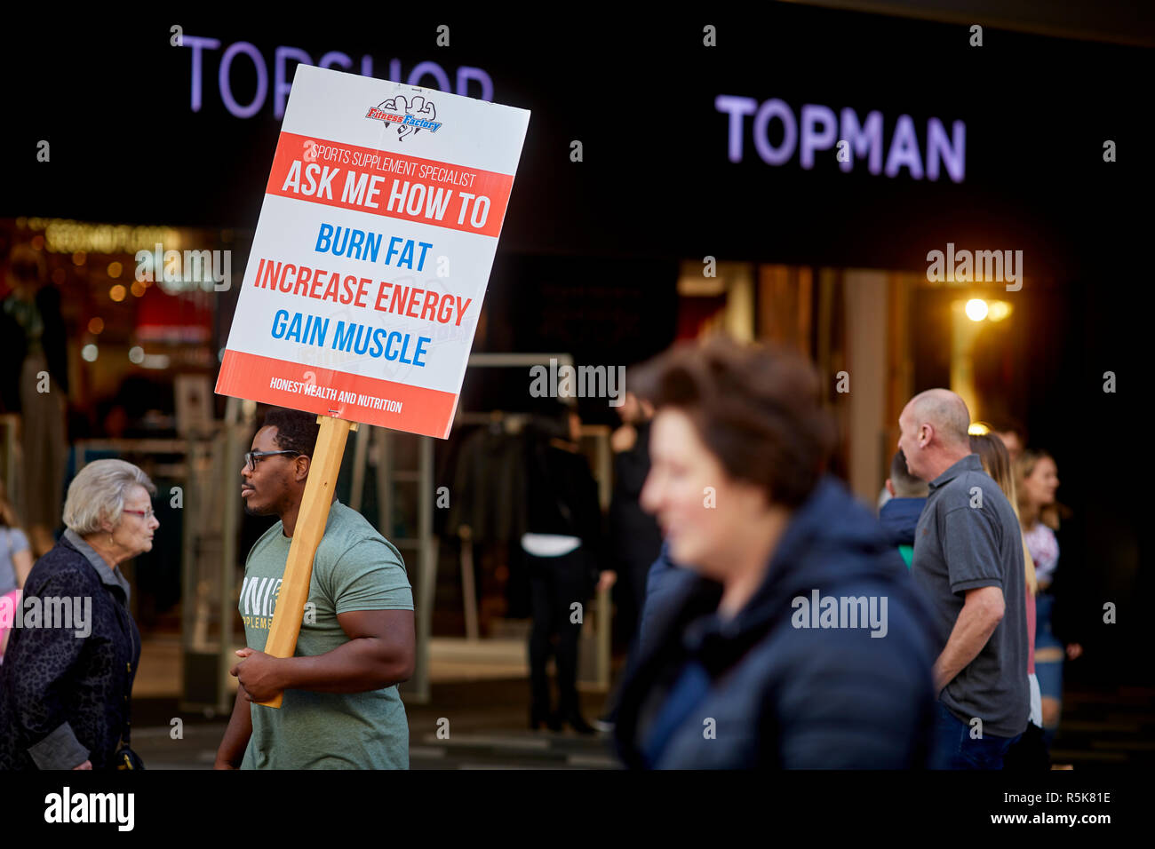 Liverpool city centre Man carrying burn fat sign promoting Fitness ...