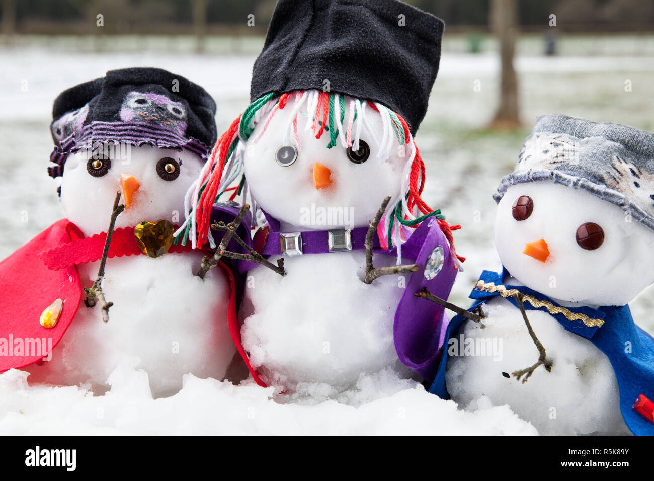 Three stylish snowmen dressed beautifully Stock Photo - Alamy